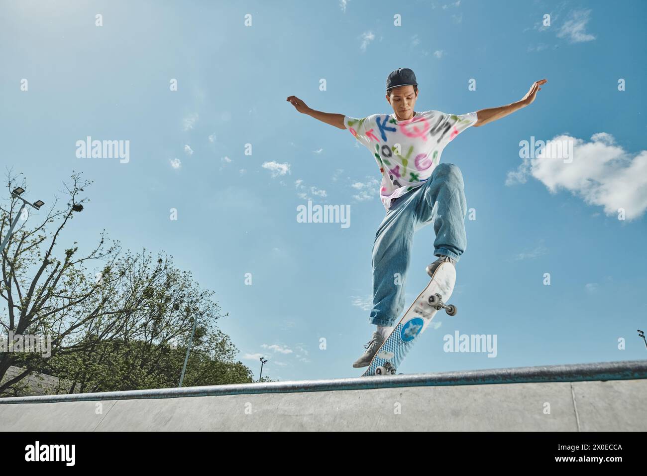 A young skater boy confidently rides his skateboard up a steep ramp in ...