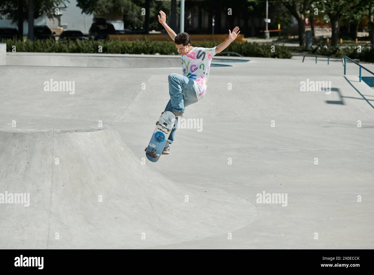 A young man defies gravity as he skillfully rides his skateboard up the ...