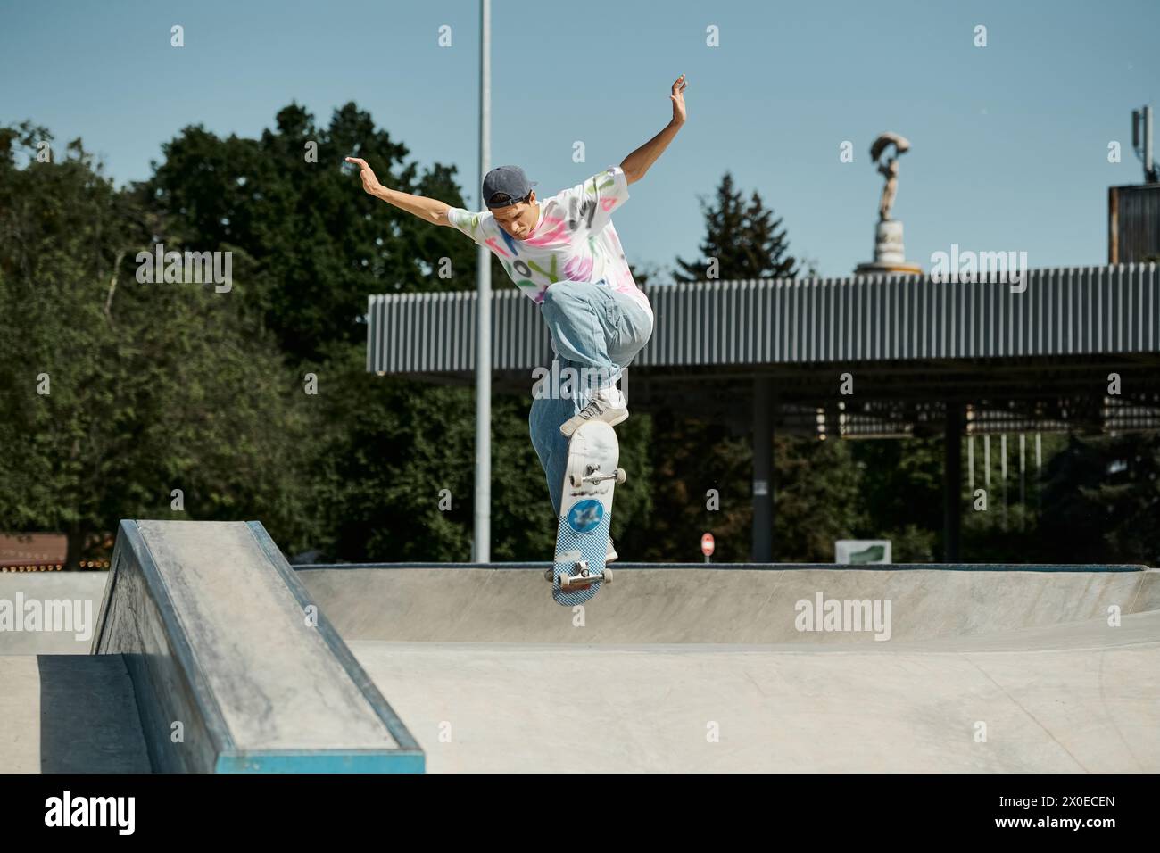 A young skater boy fearlessly riding a skateboard up the steep side of ...