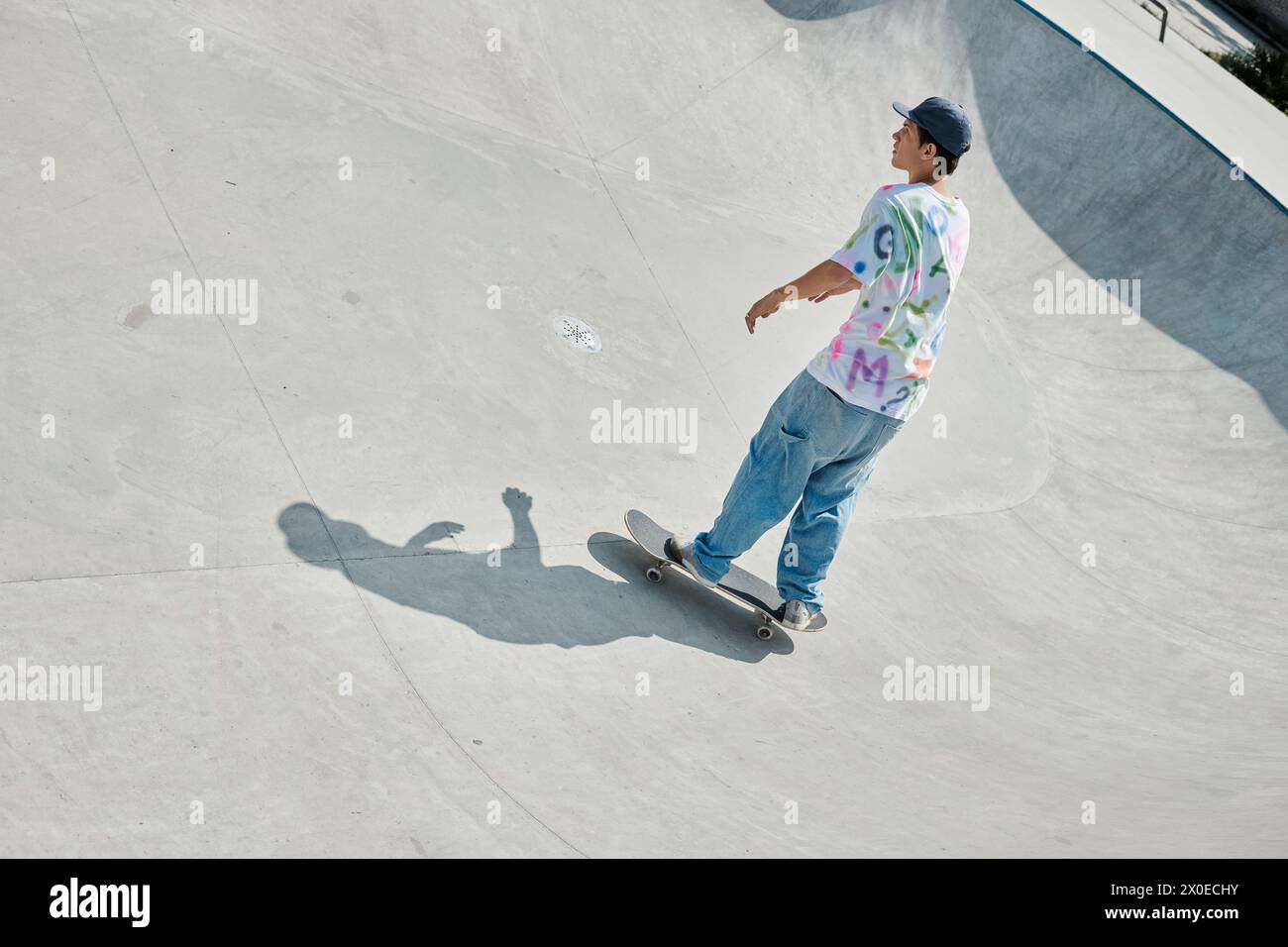 A young skater boy performing a daring skateboard descent down the ramp ...