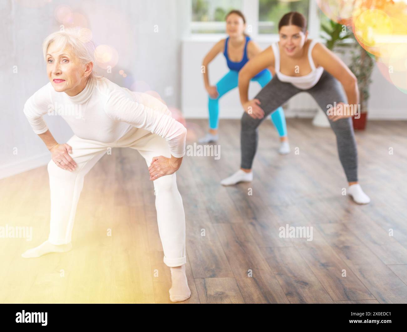 Group of active women practice various yoga poses Stock Photo - Alamy