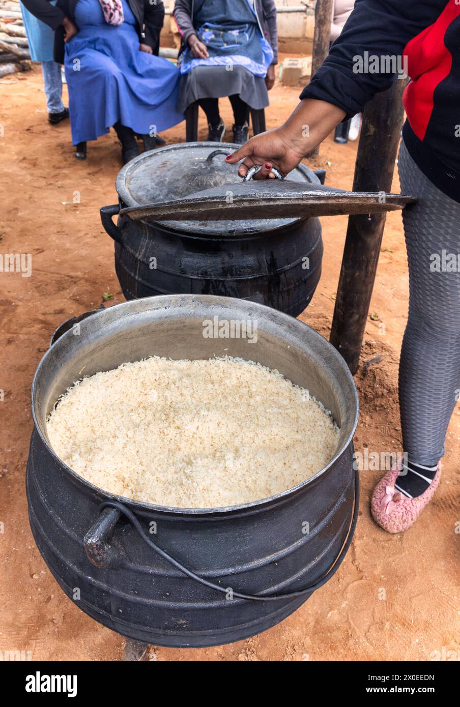 pot of rice boiling in an three legged pot, outdoors kitchen african ...