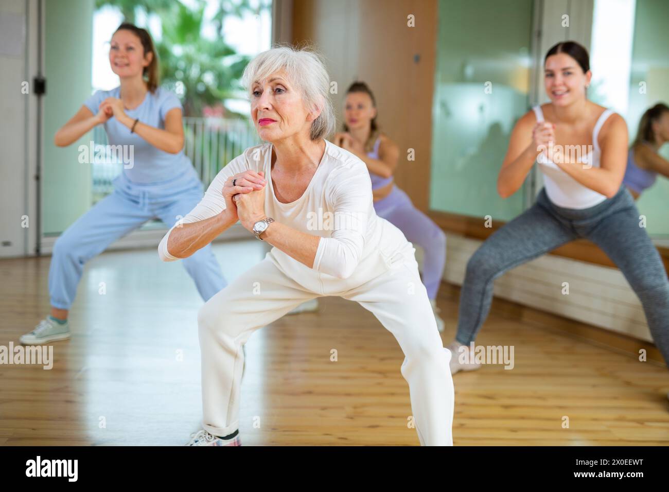 Group are practising arch movement in step jazz dance in fitness gym ...