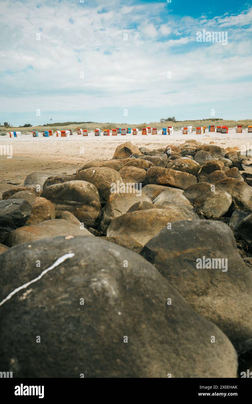 Stone groyne on beach background.Stone boulders on the beach at low ...