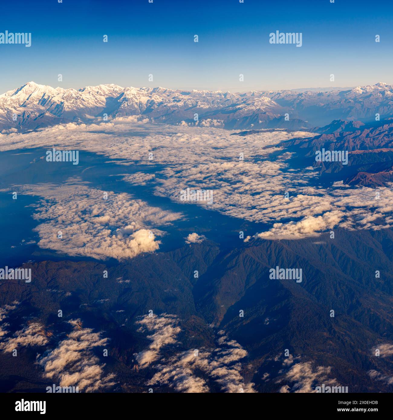 Snow capped peaks of mountains in the Himalayas and foothills near the ...
