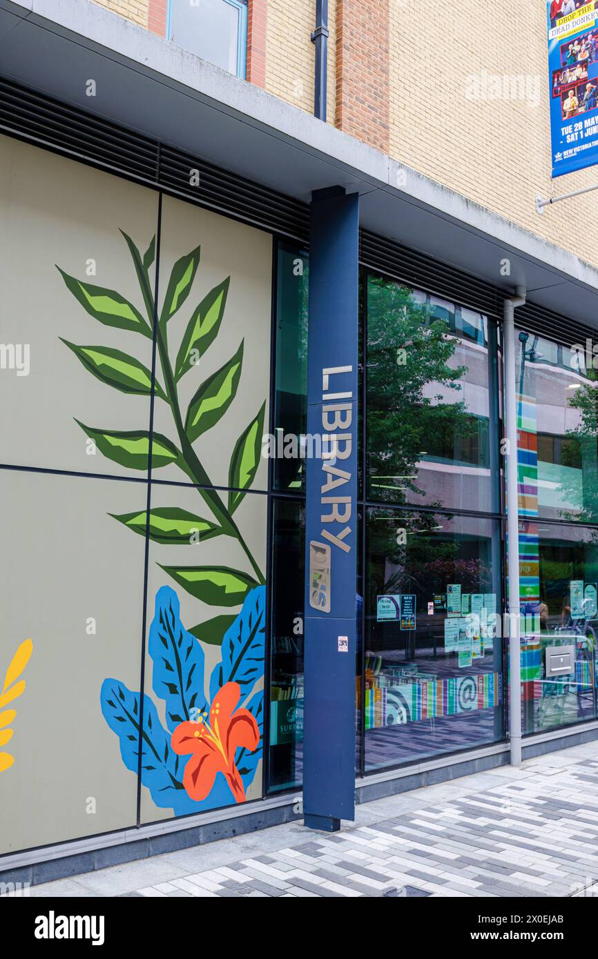 The modern glass-fronted public library in the town centre of Woking, a ...