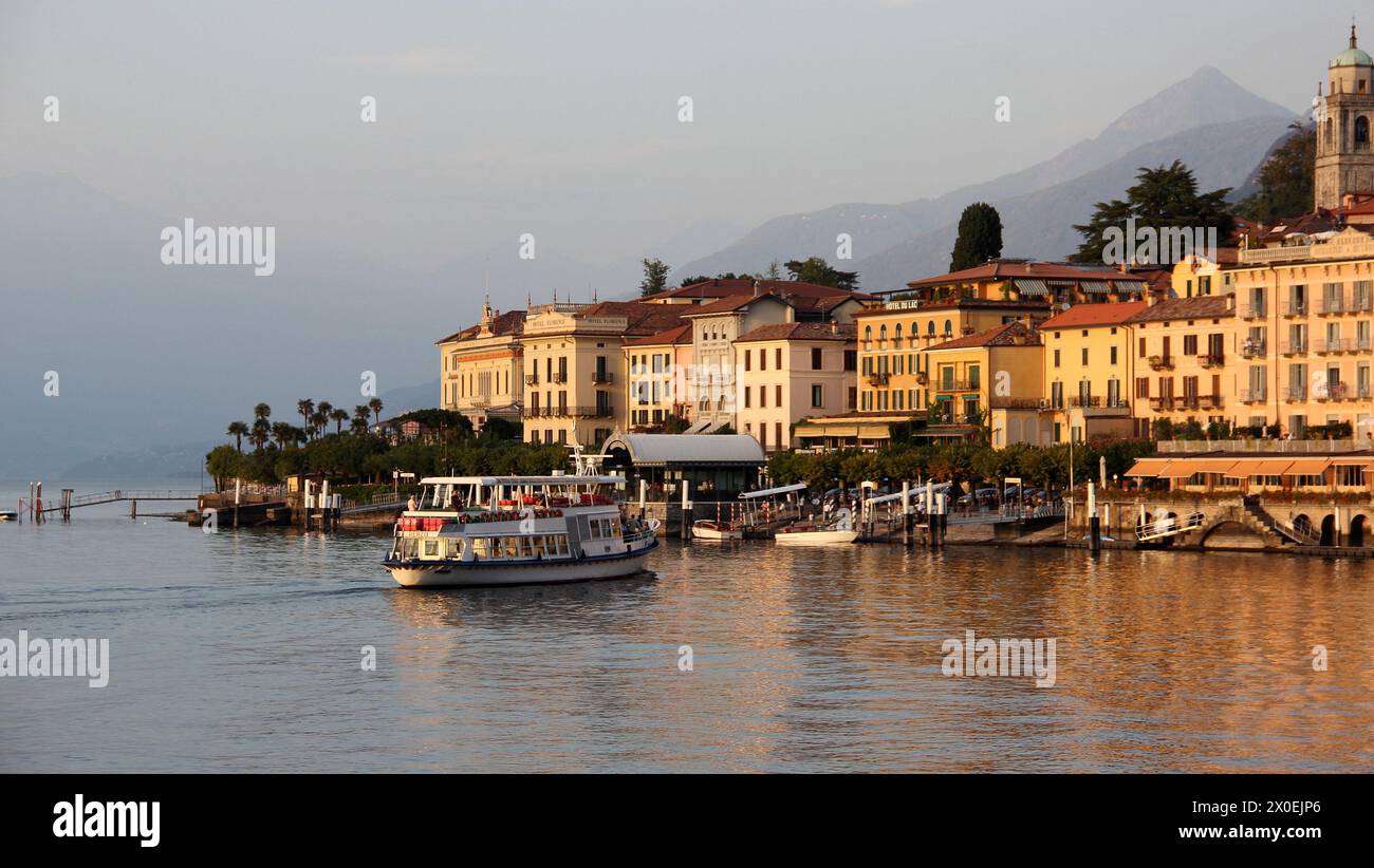 Ferry boat approaching the docking pier at sunset, Bellagio, Lake Como ...