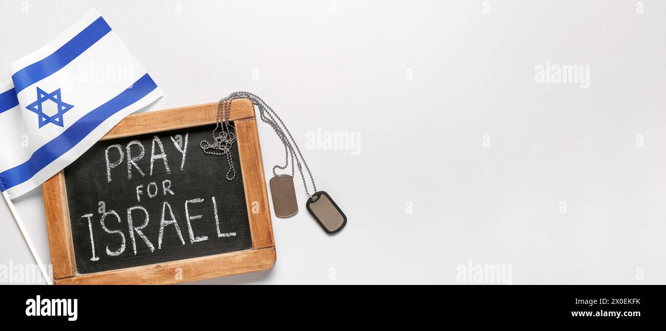 Chalkboard with text PRAY FOR ISRAEL, flag and dog tags on white ...