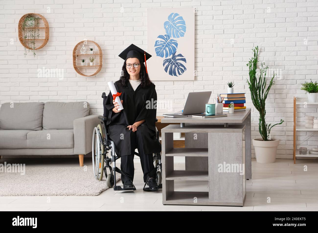 Beautiful female graduate student in wheelchair with graduation cap ...