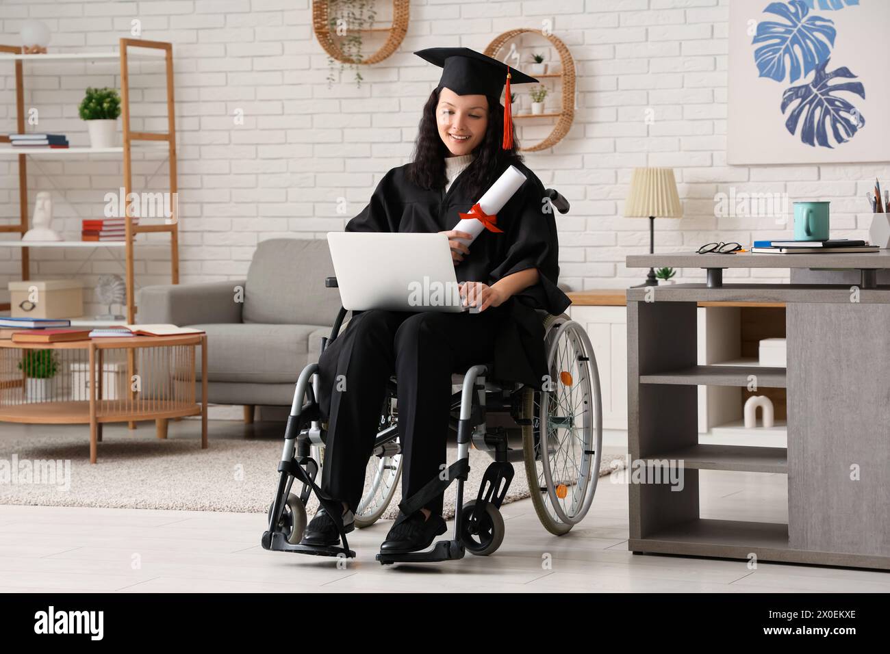 Beautiful female graduate student in wheelchair with graduation cap ...