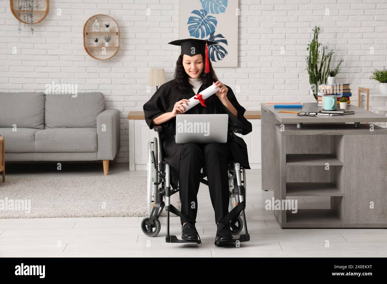 Beautiful female graduate student in wheelchair with graduation cap ...