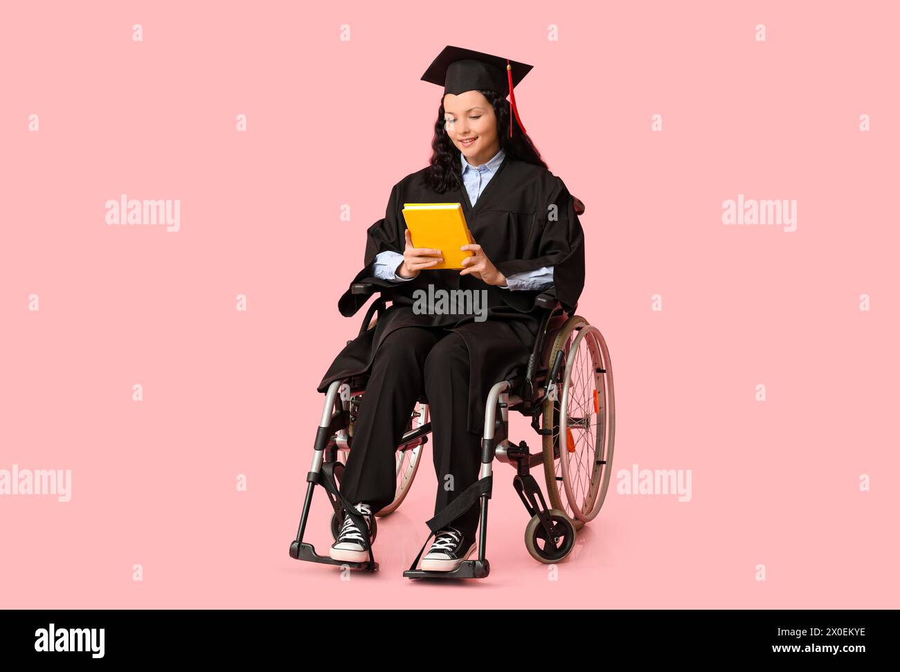 Beautiful female graduate student in wheelchair with graduation cap and ...