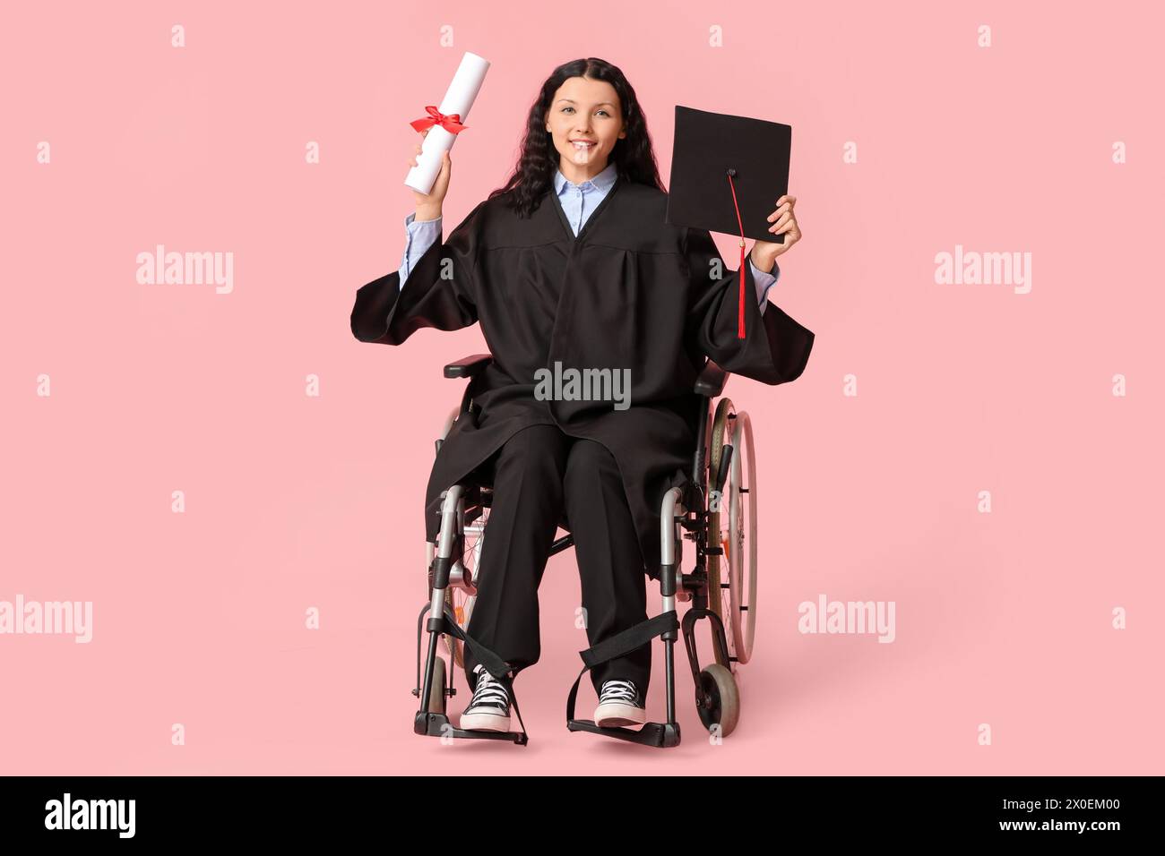 Beautiful female graduate student in wheelchair with graduation cap and ...