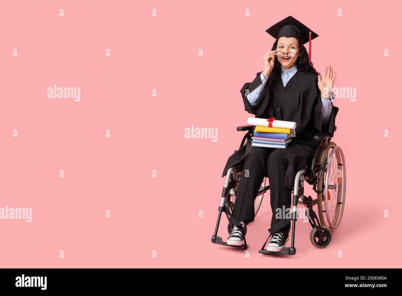 Beautiful female graduate student in wheelchair with graduation cap ...