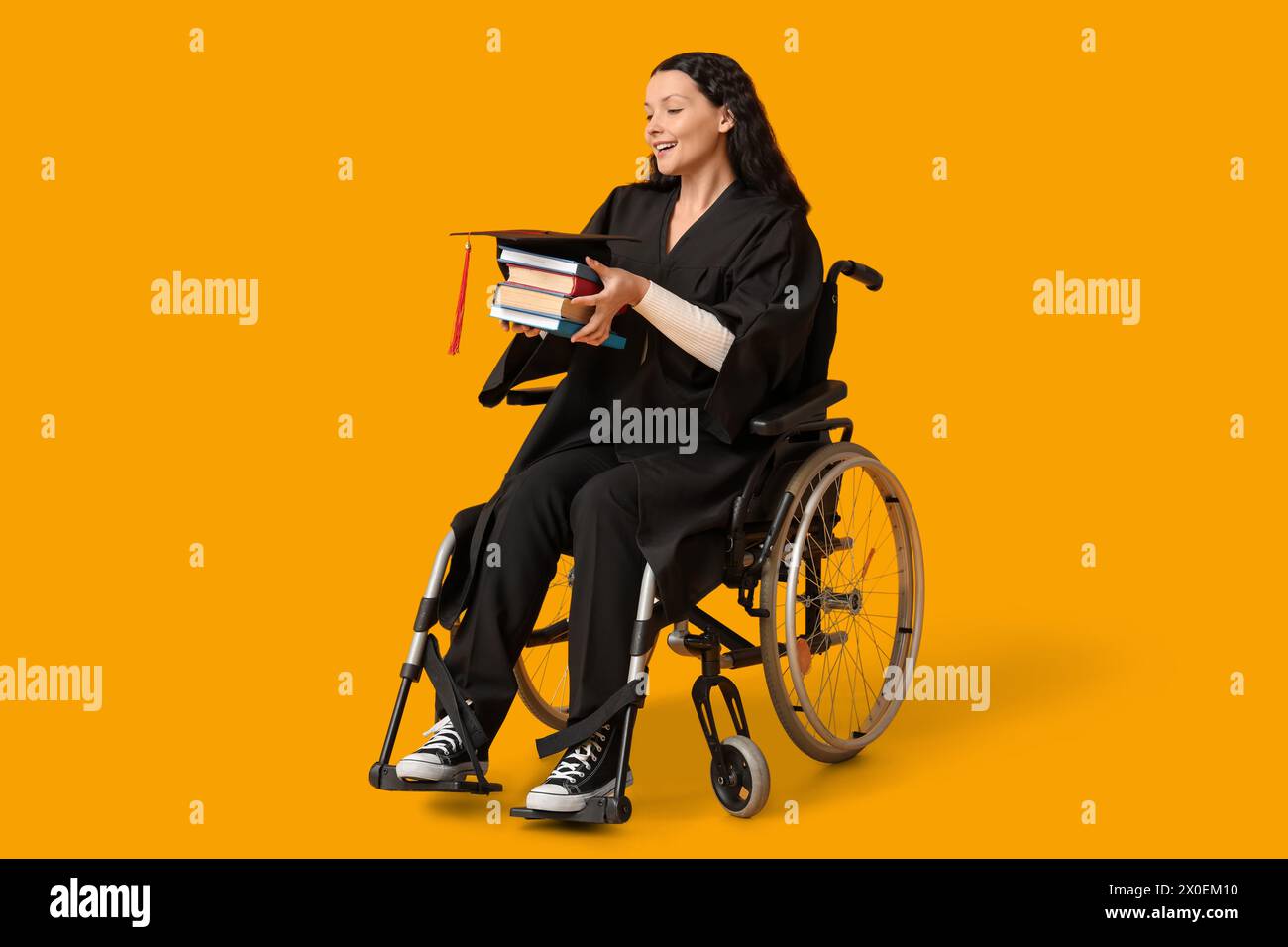 Beautiful female graduate student in wheelchair with graduation cap and ...