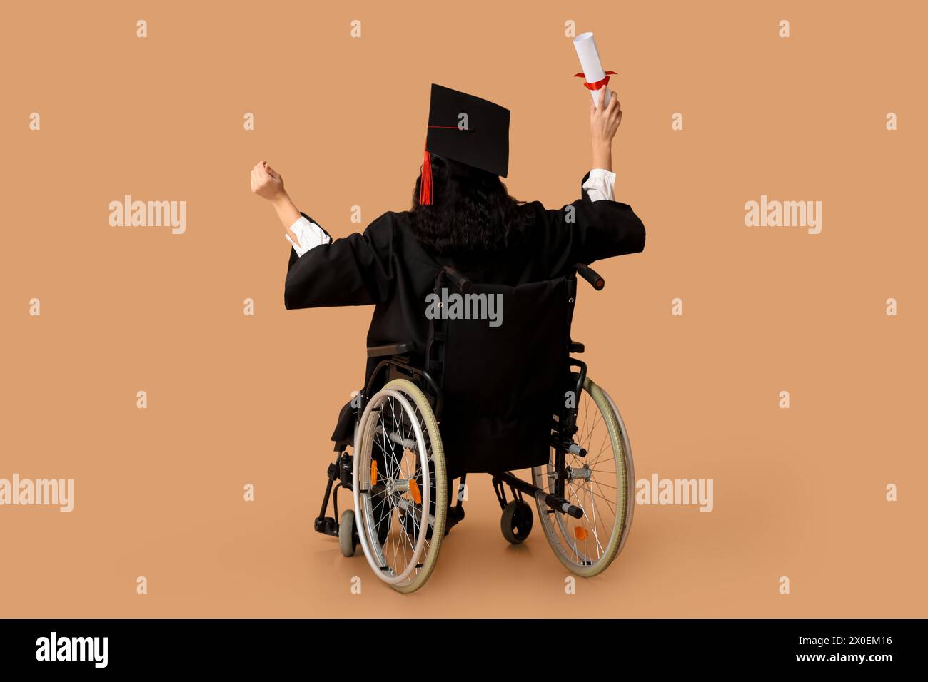 Beautiful female graduate student in wheelchair with graduation cap and ...