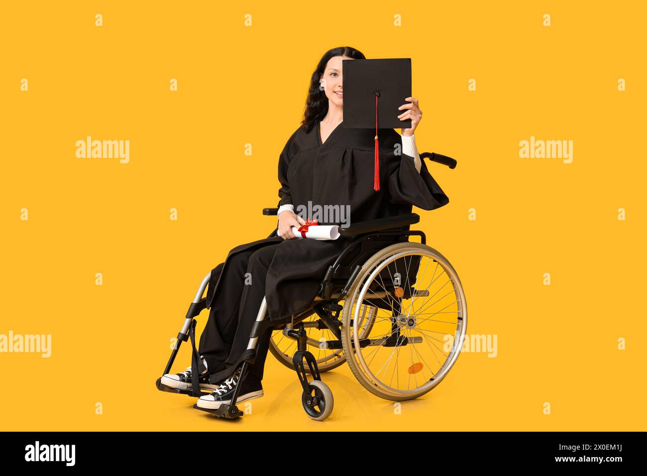 Beautiful female graduate student in wheelchair with graduation cap and ...