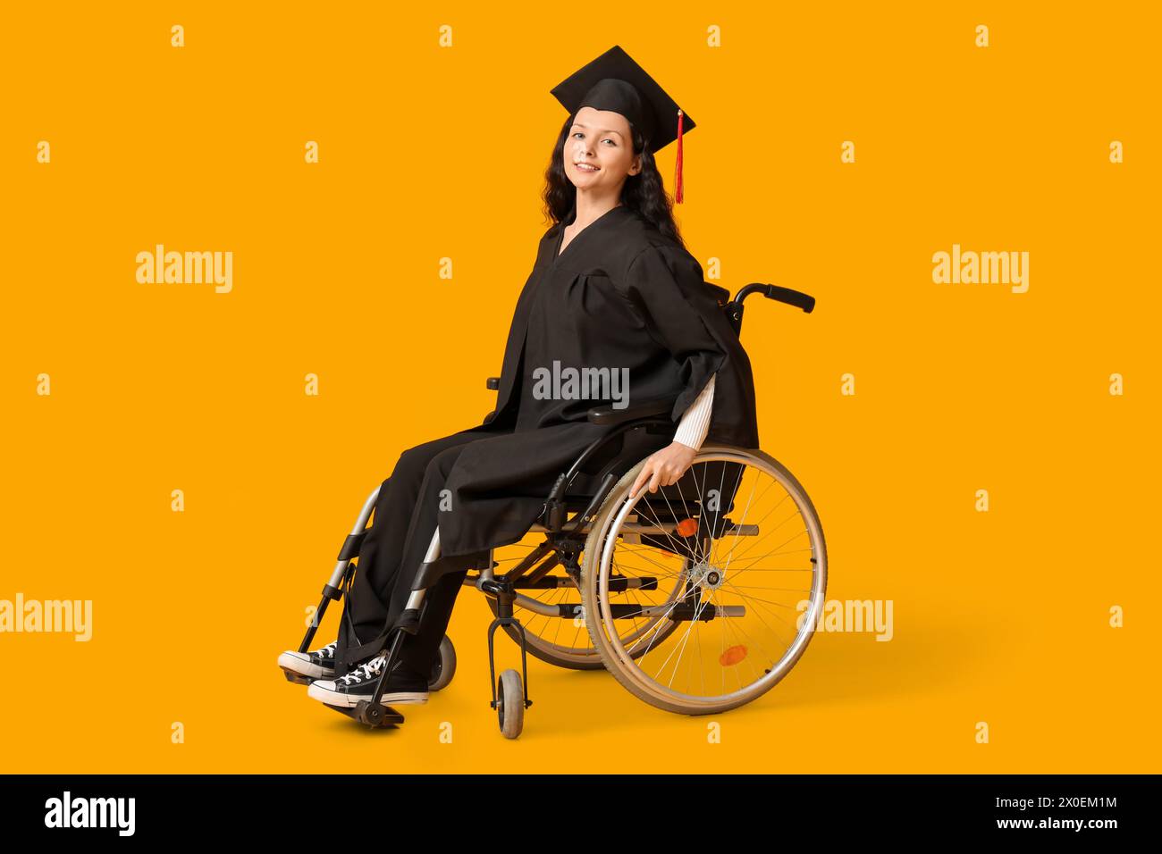 Beautiful female graduate student in wheelchair with graduation cap on ...