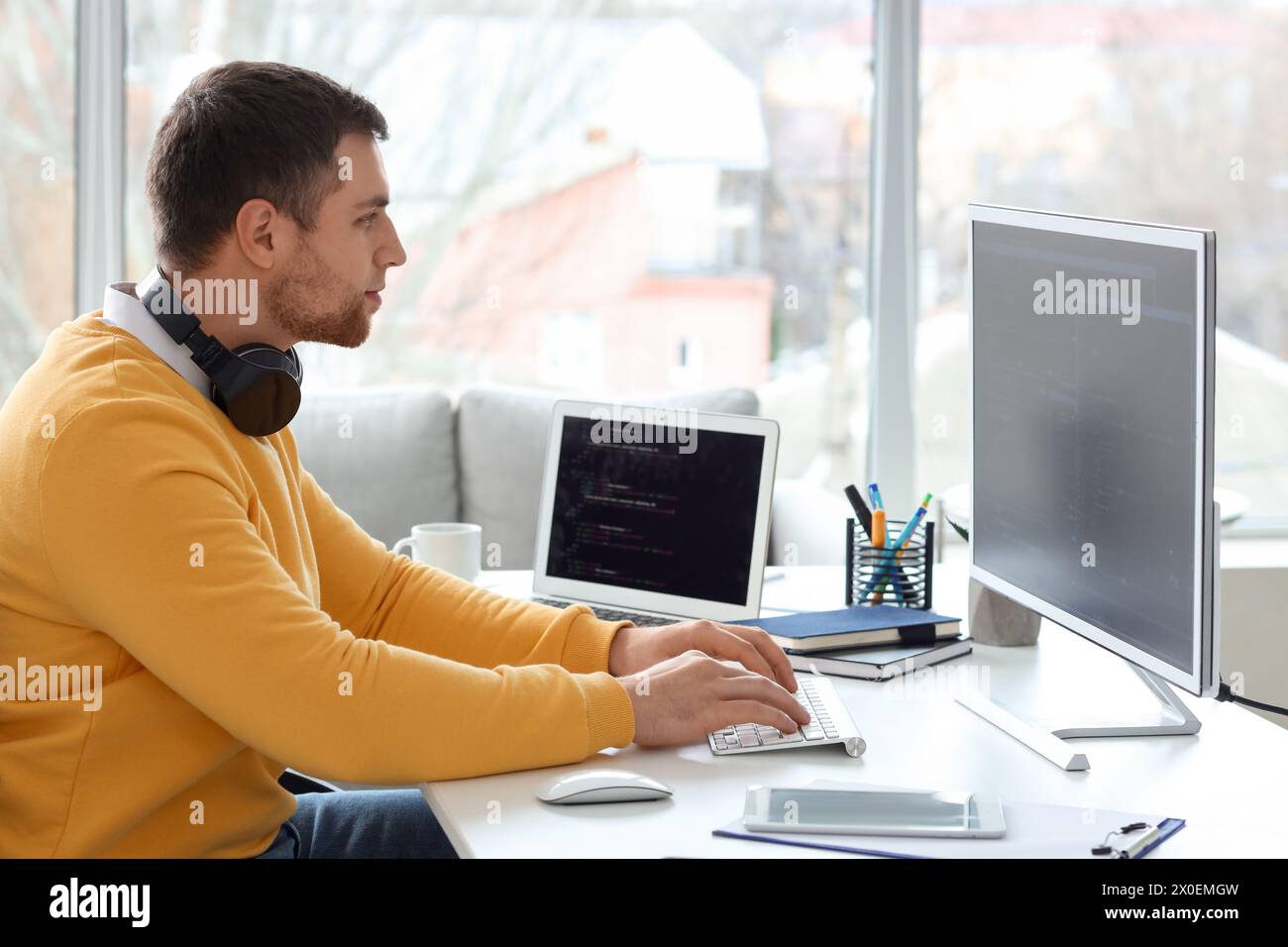 Portrait of focused male programmer working with computer in office ...