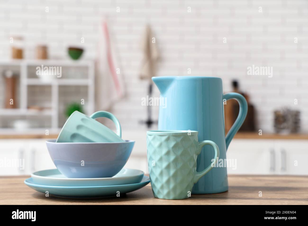 Set of clean blue dishes on table in kitchen Stock Photo - Alamy