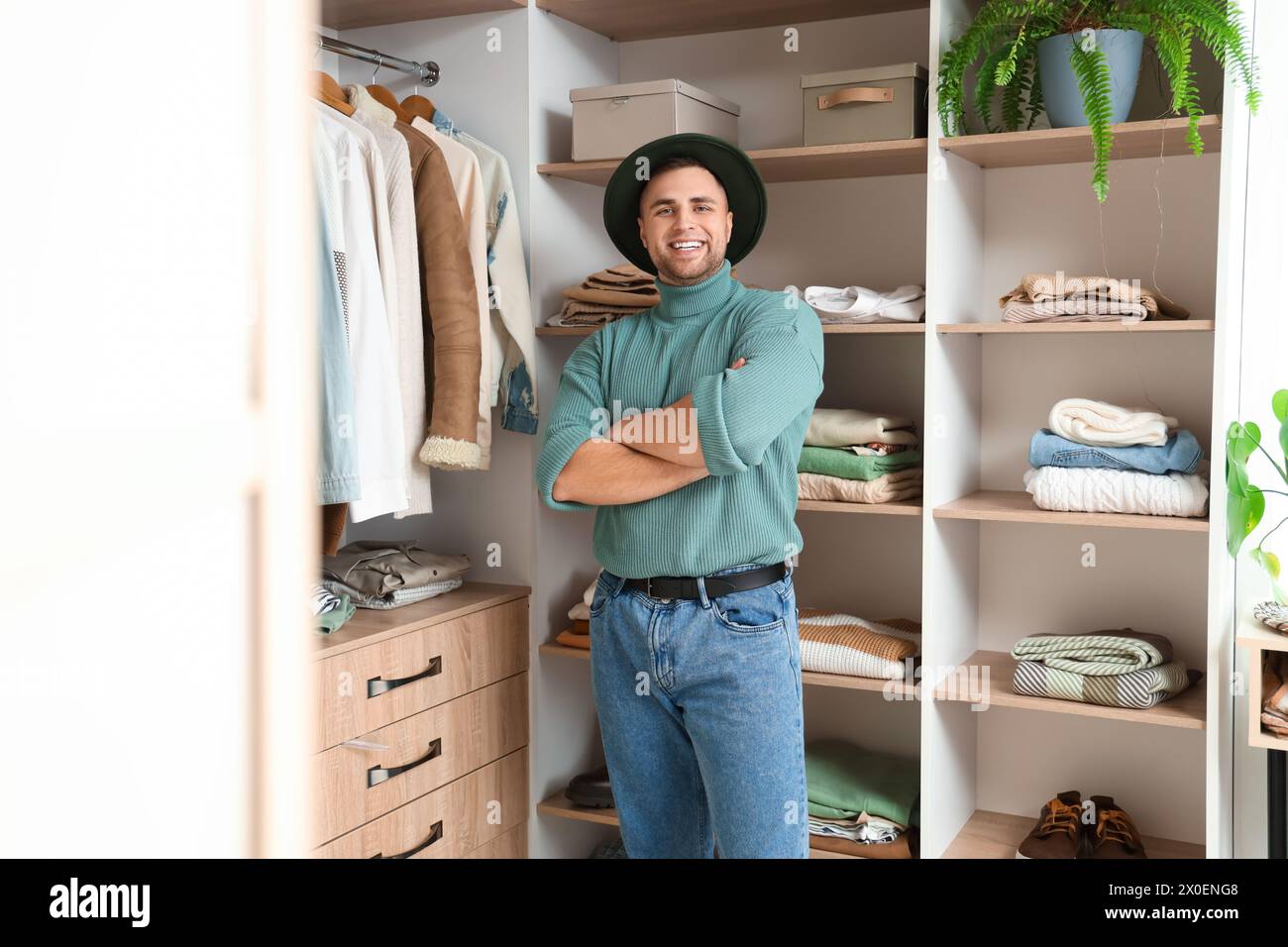 Young man with hat and clothes in walk-in closet Stock Photo - Alamy
