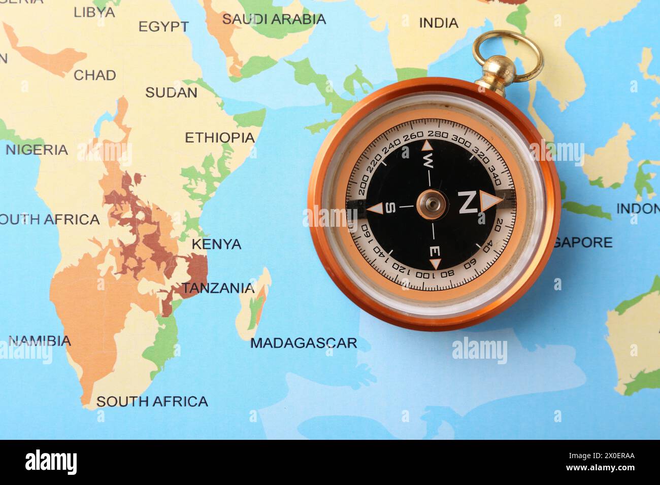 One compass on world map, top view. Space for text Stock Photo - Alamy