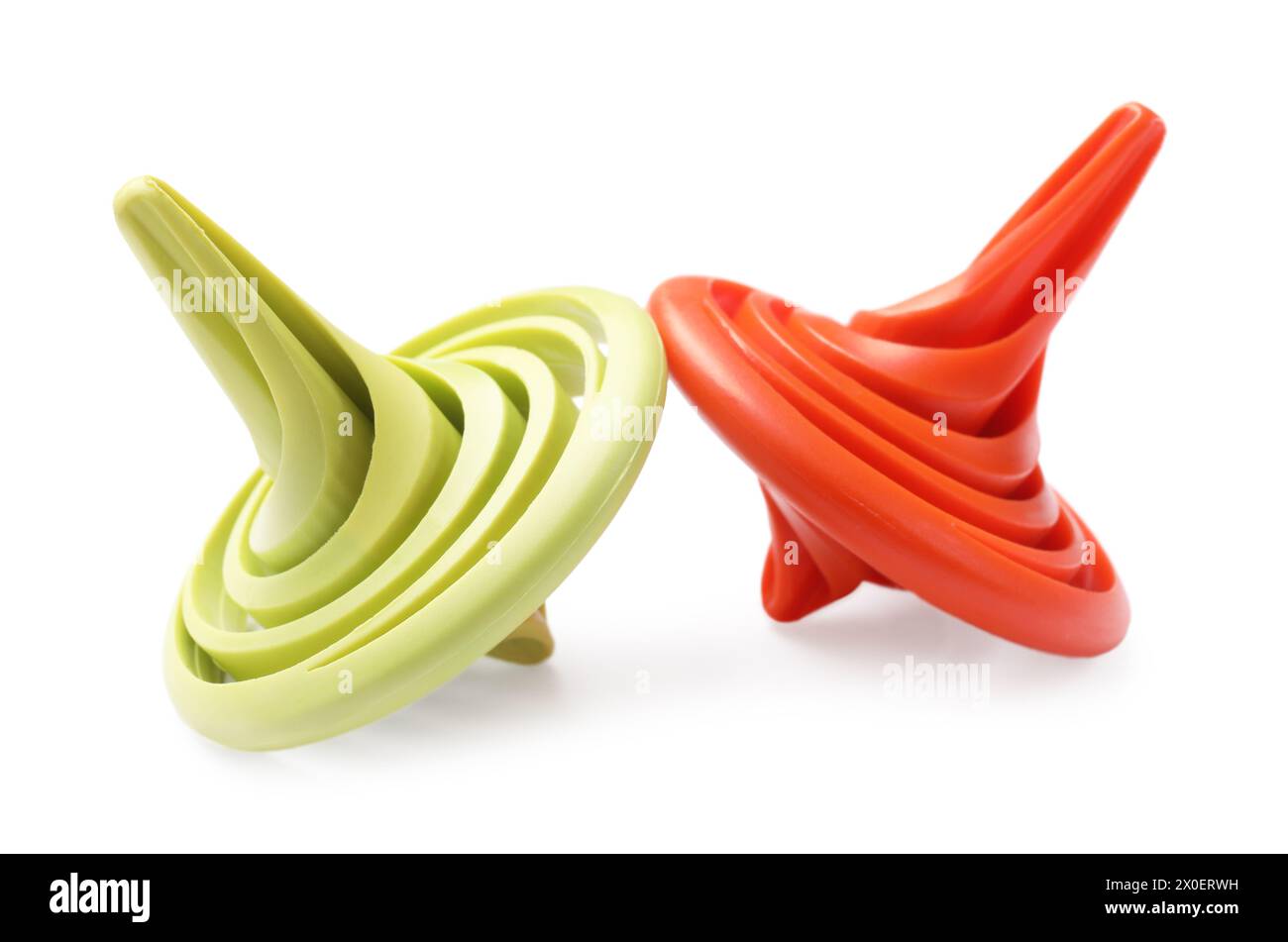 Two colorful spinning tops on white background Stock Photo - Alamy