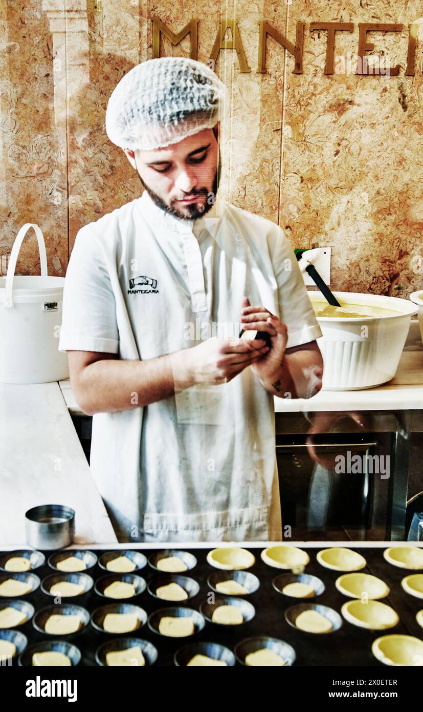 Baker making Pastel de Nata, Pasteis de Nata, a Portugese custard tart ...