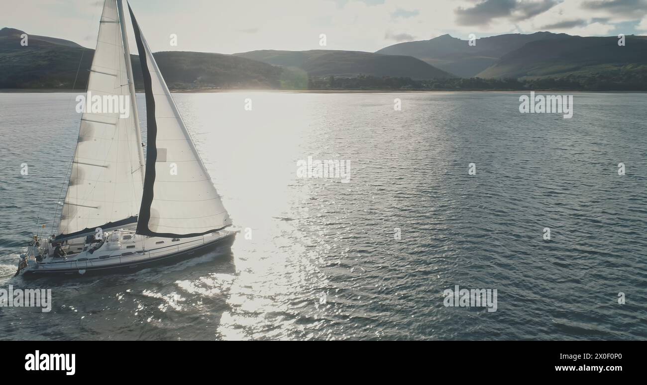 Sun over luxury yacht at ocean coast aerial. Majestic sailboat regatta ...