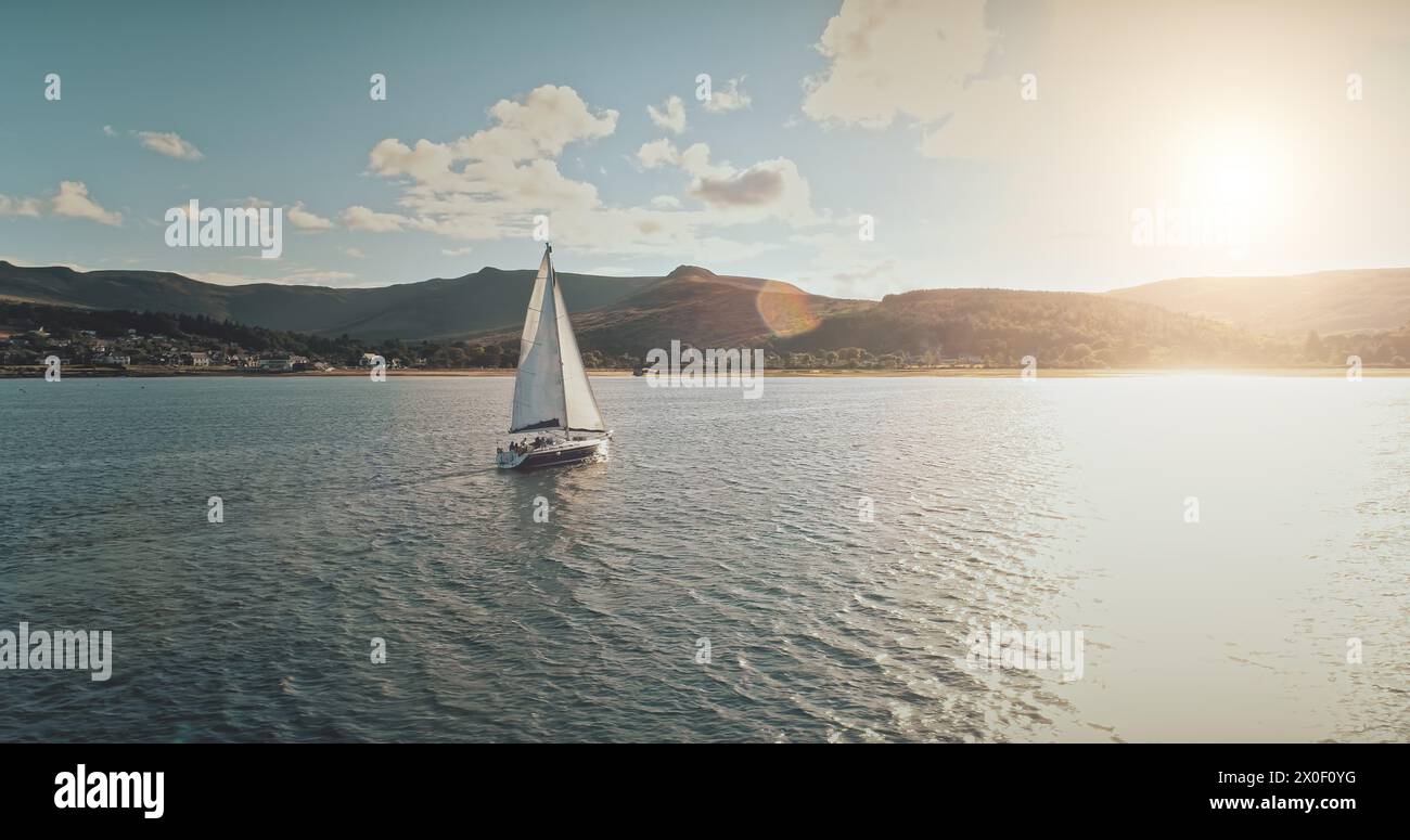 Sailing yacht in wind waves at Arran Island sea bay in Scotland ...
