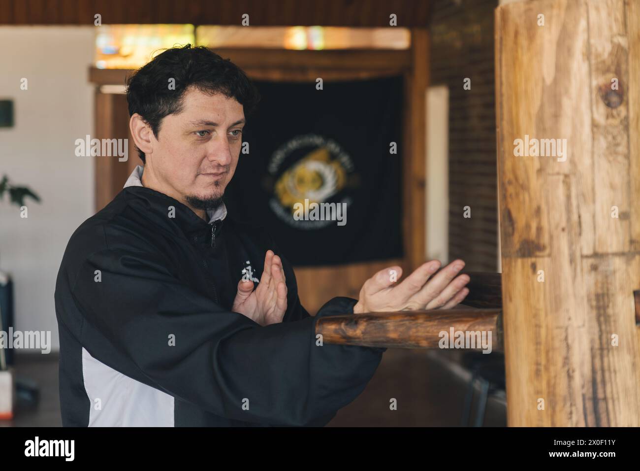 Man practicing traditional Wing Chun Kung Fu training with the Wooden ...