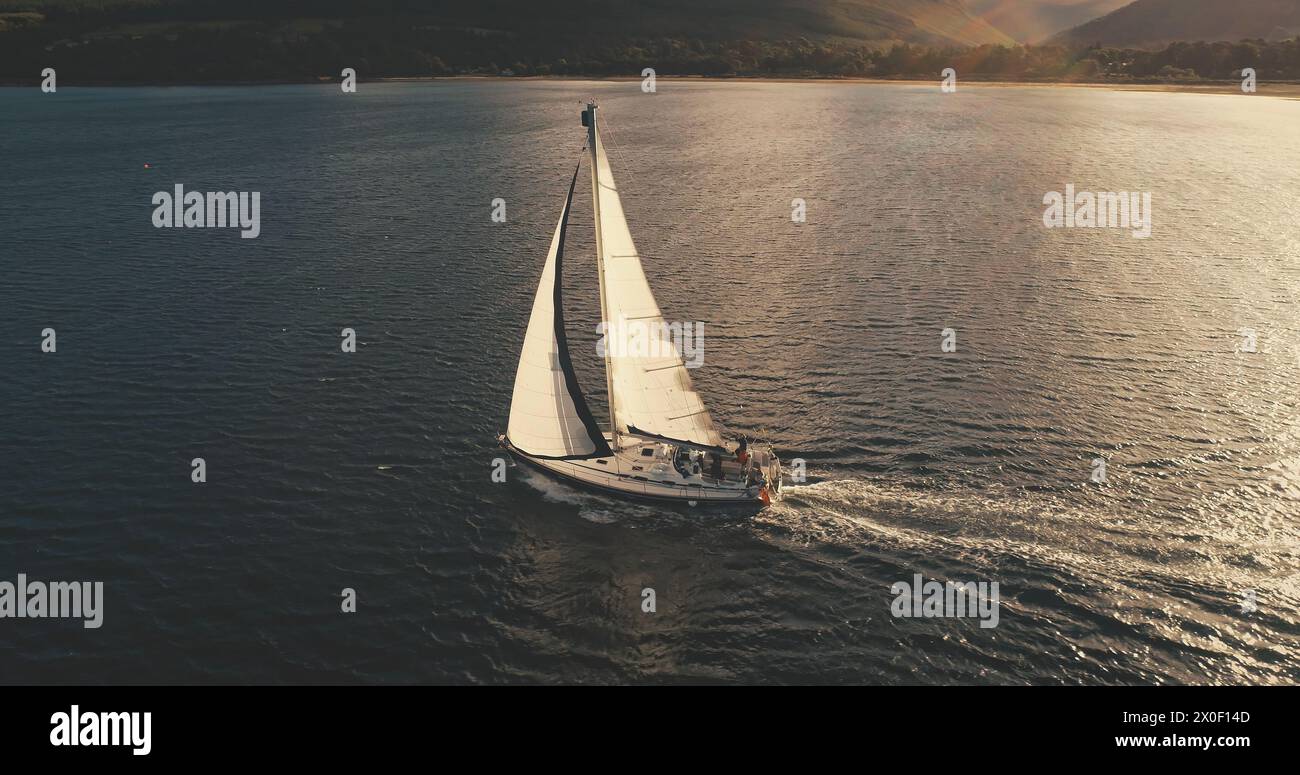 Yacht cruise in sunlight reflection at open sea bay aerial. Luxury ...
