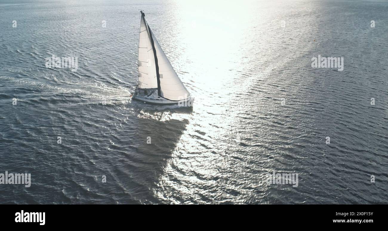 Sun seascape with alone sail boat aerial. Luxury yacht at open sea ...