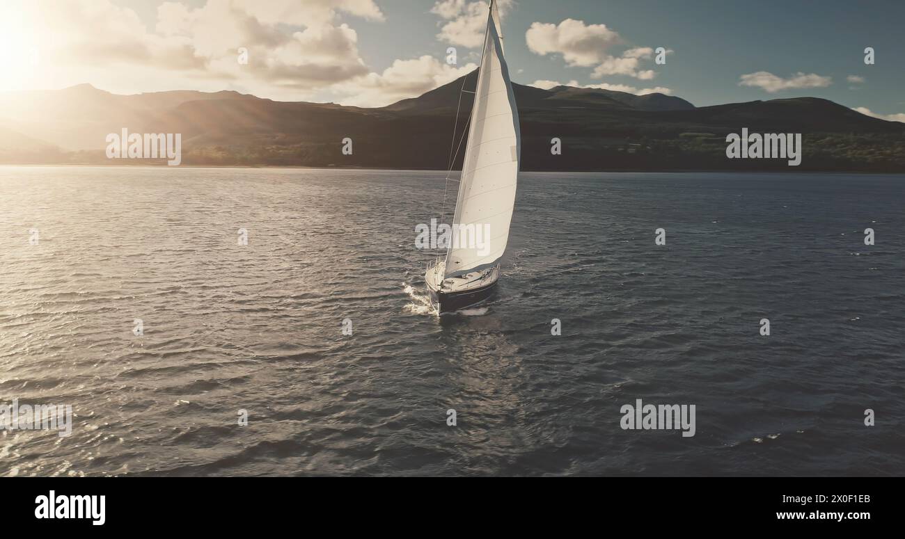 Sun seascape with white sails yacht in open sea aerial. Sailing on ...