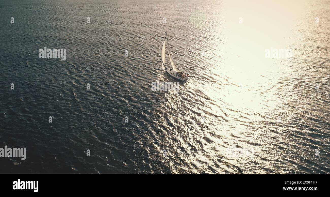 Aerial yacht sailing on opened sea at sun light. Epic seascape with ...