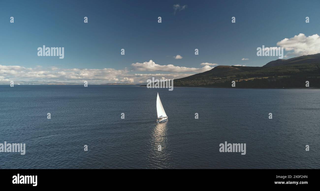 Aerial racing yacht at mountainous island. Luxury ship at mountain ...