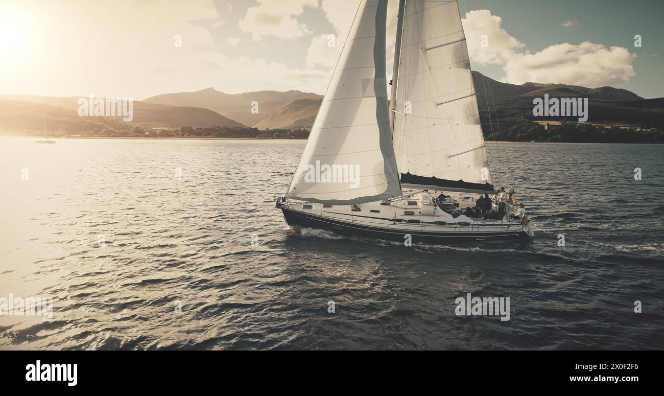 Aerial slow motion of yacht regatta sailing at sun reflection on ocean ...