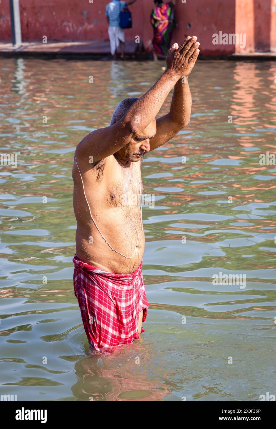 devotee praying after bathing in holy river water at morning from flat ...