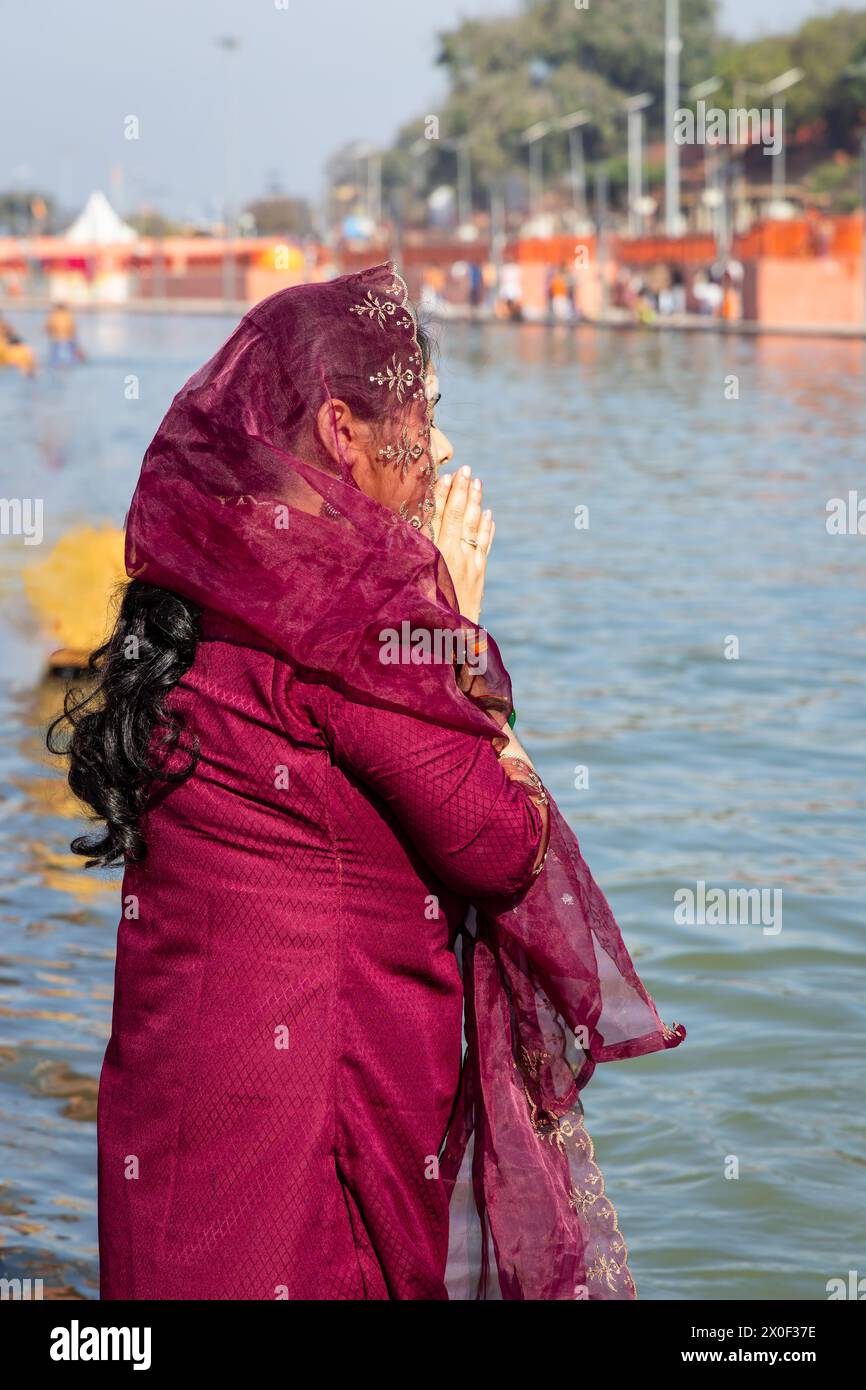 young devotee praying for holy god after bathing in holy river water at ...