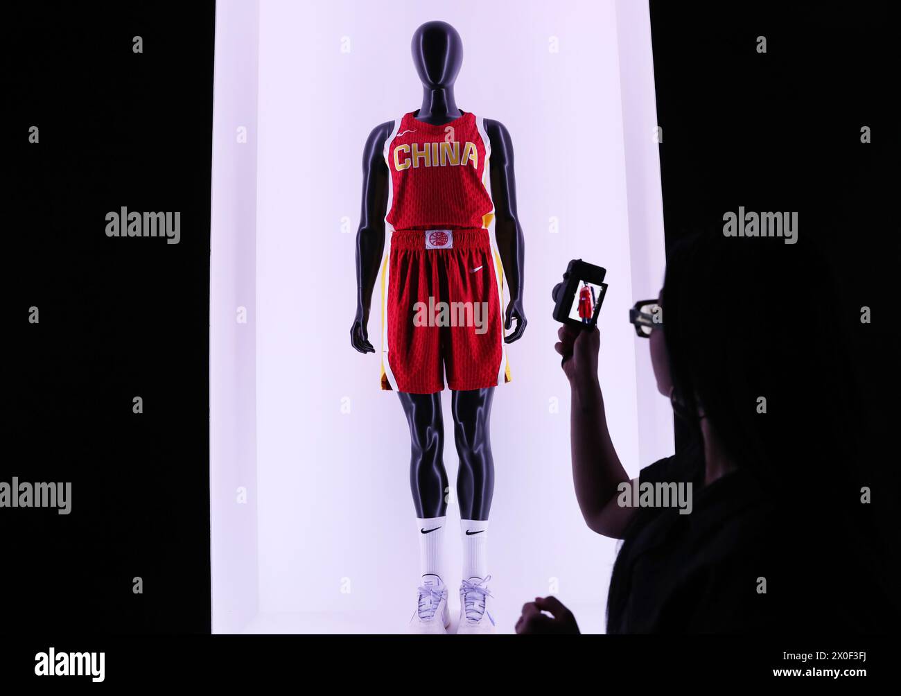 Paris, France. 11th Apr, 2024. A visitor takes photos of Nike Olympics ...