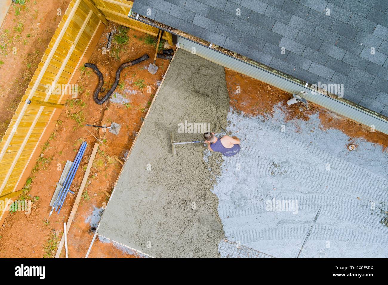 In preparation for driveway of new house wet cement has been poured ...