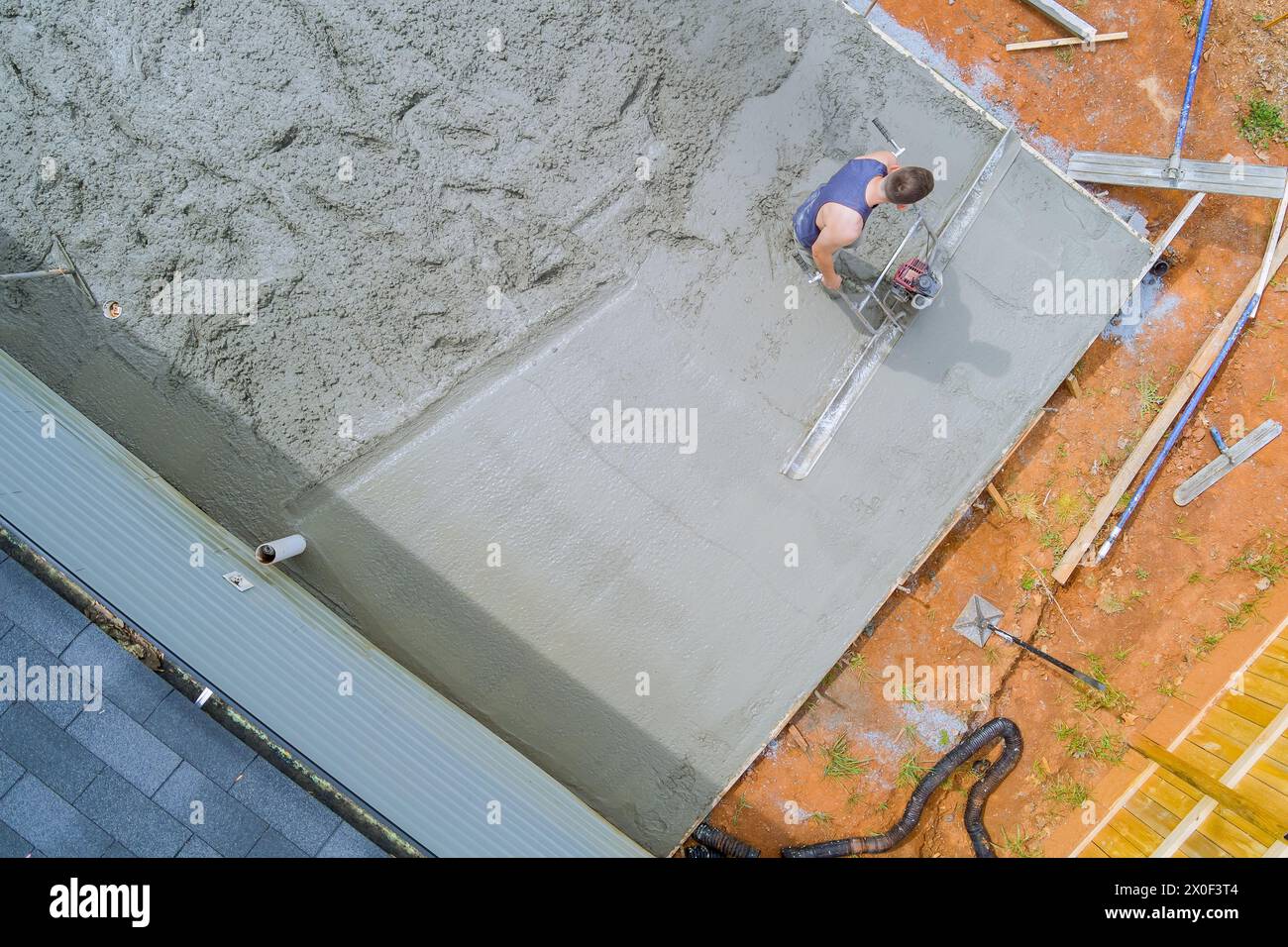 Leveling concrete by using special tool by construction worker Stock ...