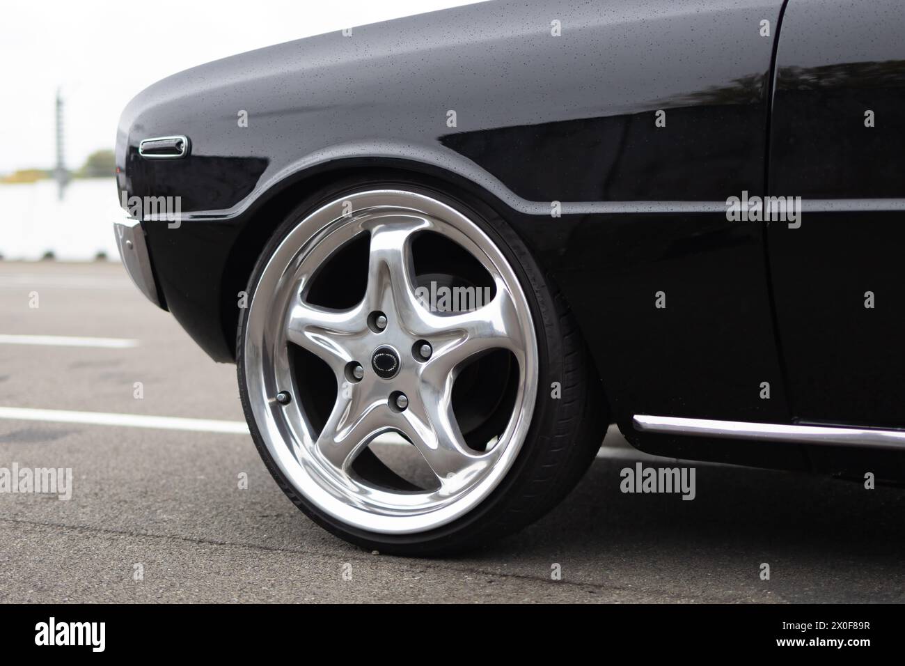 Black Mazda 1300 sedan with low stance and alloy wheels Stock Photo - Alamy