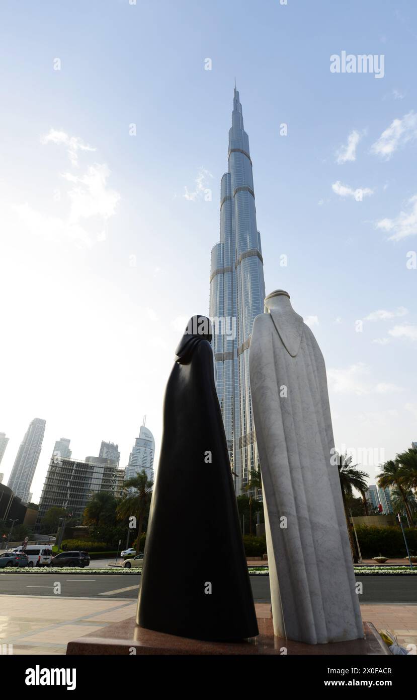 The Burj Khalifa skyscraper and the Arabic Couple Statue in downtown ...