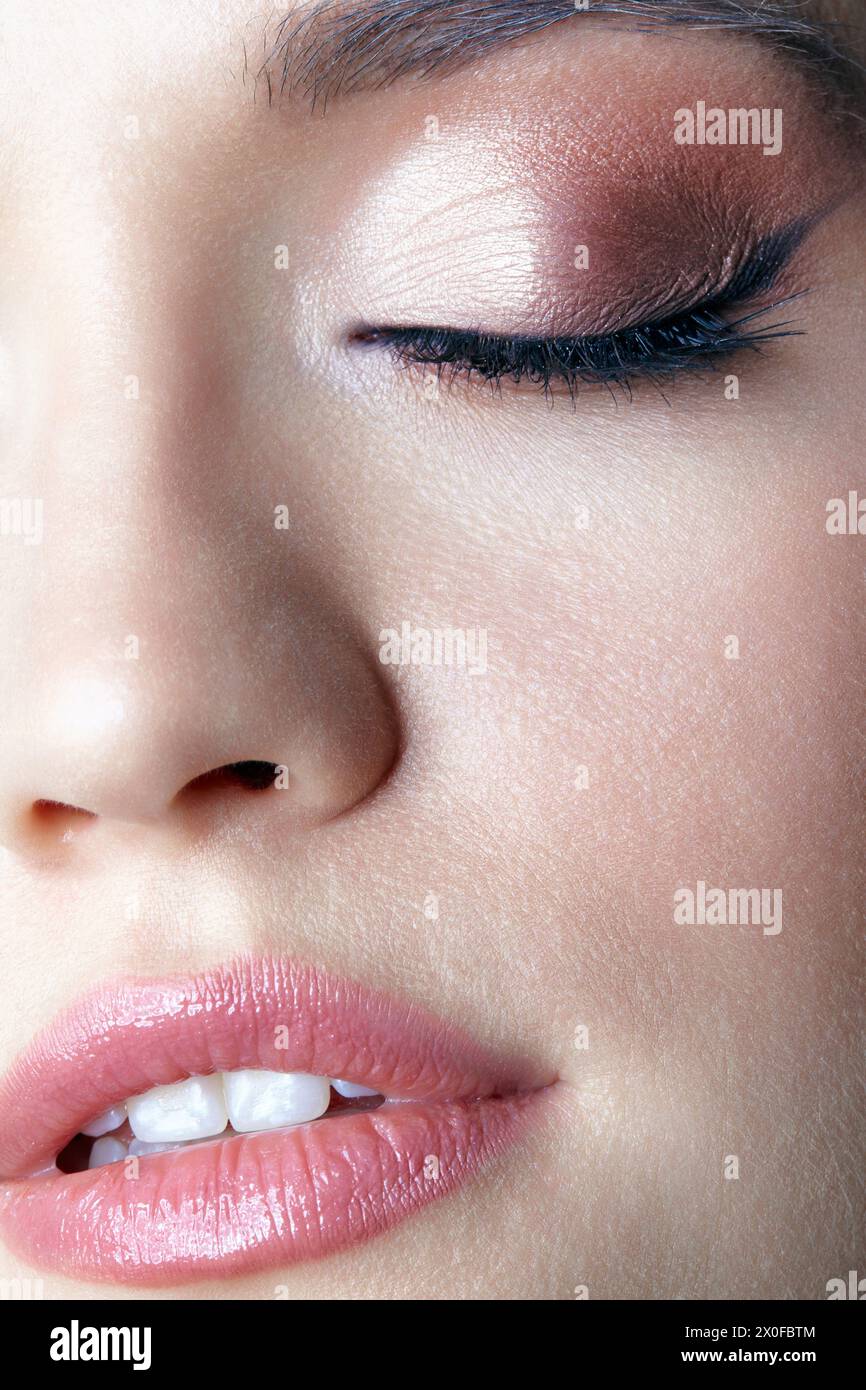 Closeup macro shot of human female face. Woman with closed eyes and ...