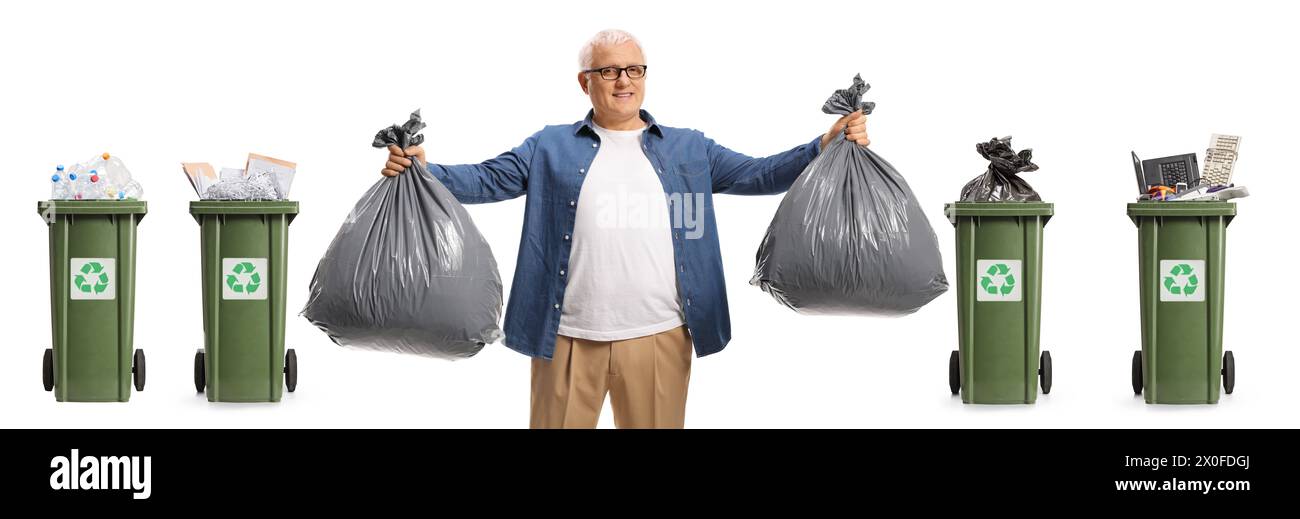 Mature man with waste bags and recycling bins for different materials ...