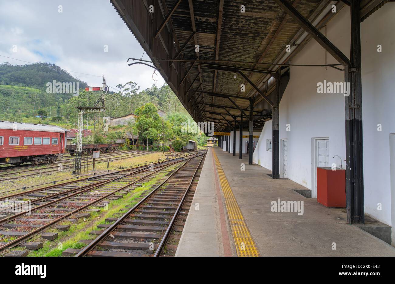 A tranquil railway station, with empty tracks leading the eye towards ...