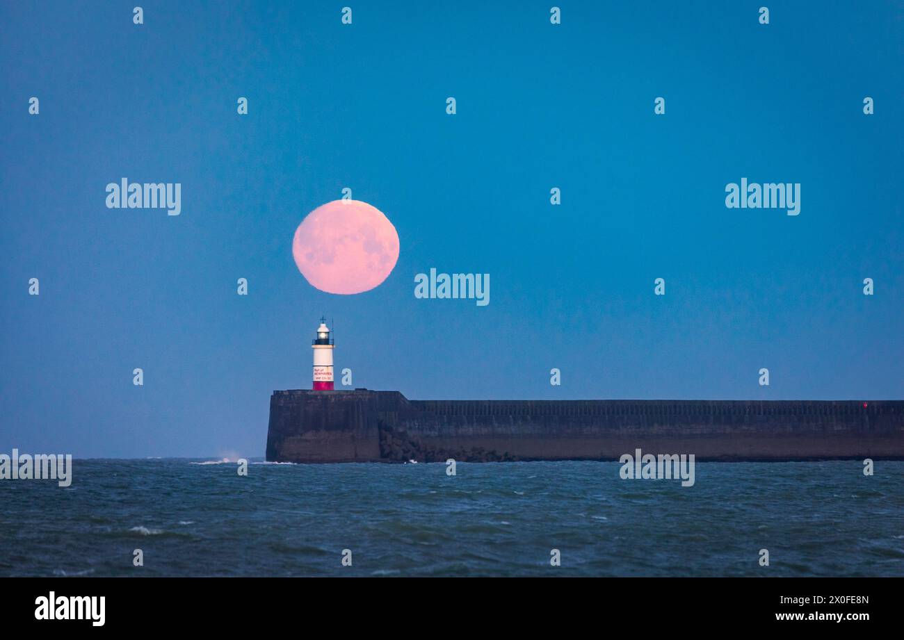 March full moon setting behind Newhaven lighthouse from Seaford beach ...