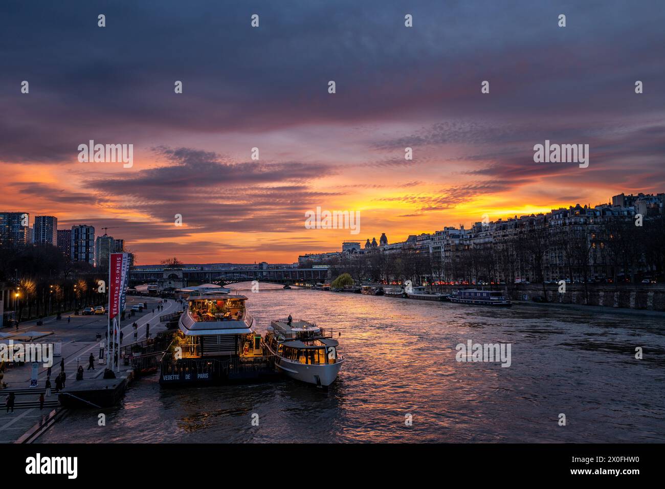 Eiffel Tower at sunset, with the Parisian cityscape in the background ...