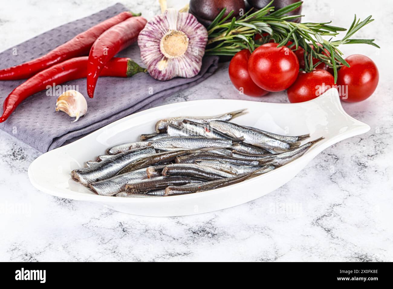 Pickled anchovy fish in the plate Stock Photo - Alamy